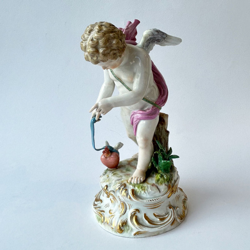 Meissen Porcelain Figure of Cupid Capturing A Heart with Blue Ribbon